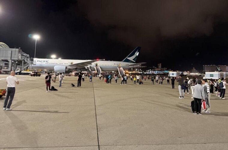 Passengers of a Cathay Pacific Boeing 777-300 were evacuated via ...